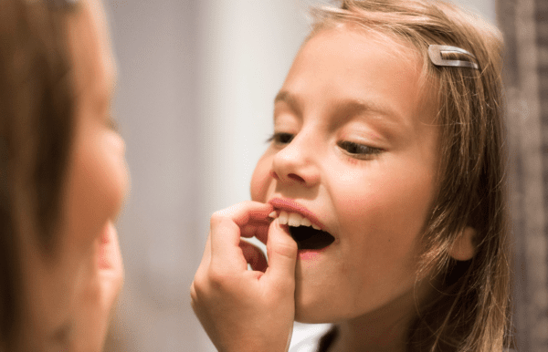 How to Pull a Tooth Without Pain: A Parent's Guide (2022) - Milwaukee ...